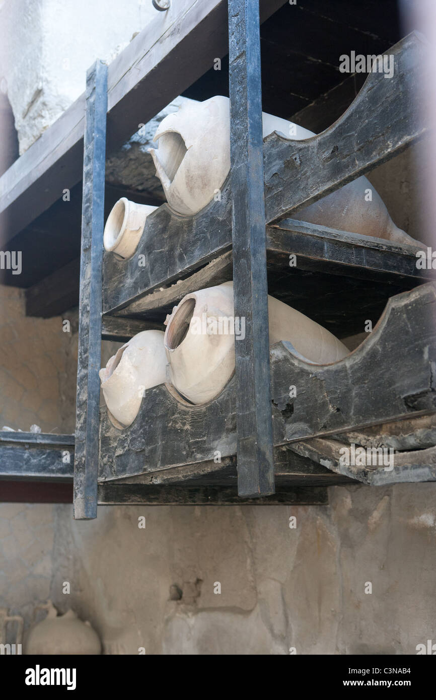 Cylindrical Amphora (Roman, AD 79) housed in carbonized storage racks ...