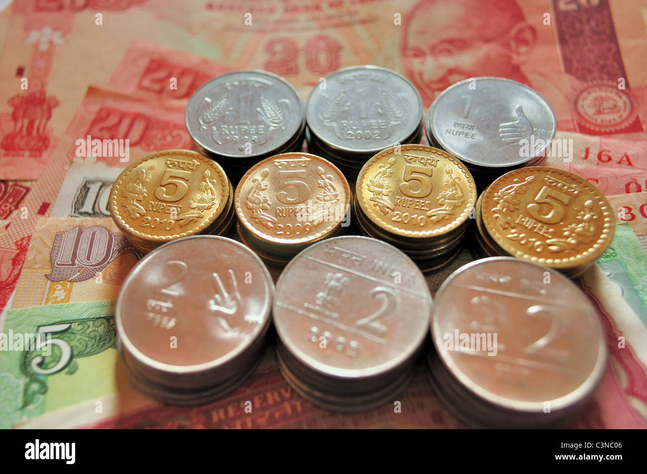 Stack of Indian currency coins on some Indian currency bank notes Stock ...