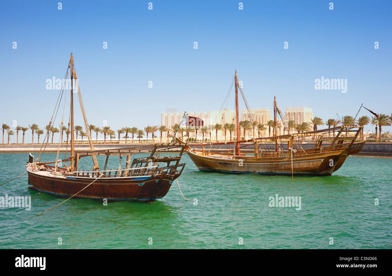Dhows moored in Doha Bay, Qatar. A jalibut is on the left and a boom on ...