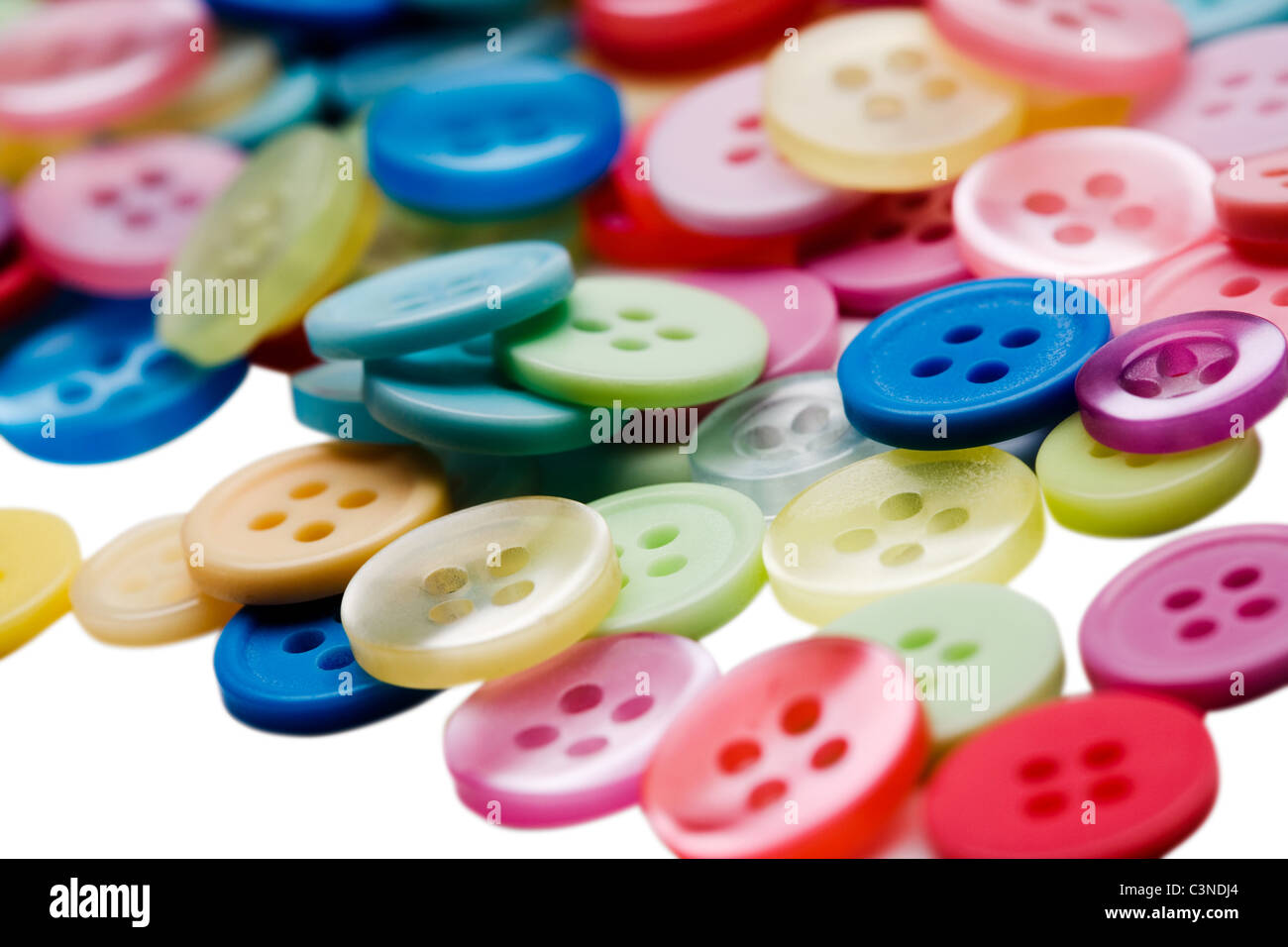 Heap of colorful buttons isolated over white Stock Photo - Alamy