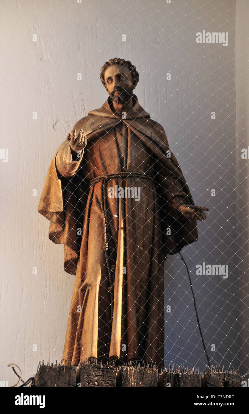 Portrait of brown Franciscan friar statue, above the entrance of the ...