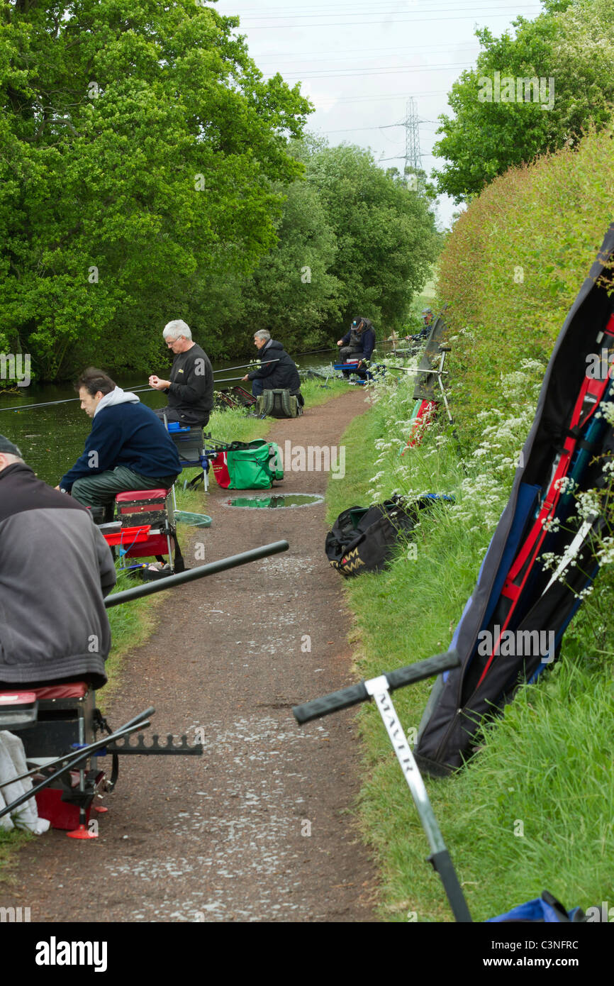 Anglers fishing on a canal towpath Stock Photo - Alamy