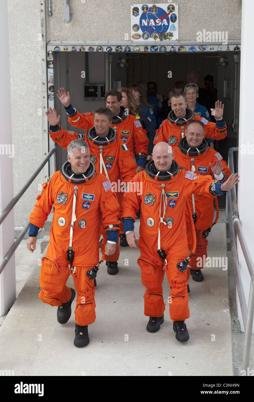 Space shuttle Endeavour's astronauts, dressed Commander Mark Kelly (R ...