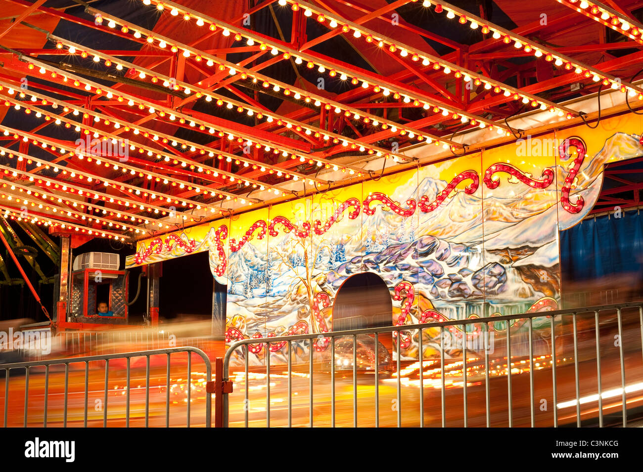 Rides at the Evergreen State Fair with bright multicolored lights ride ...