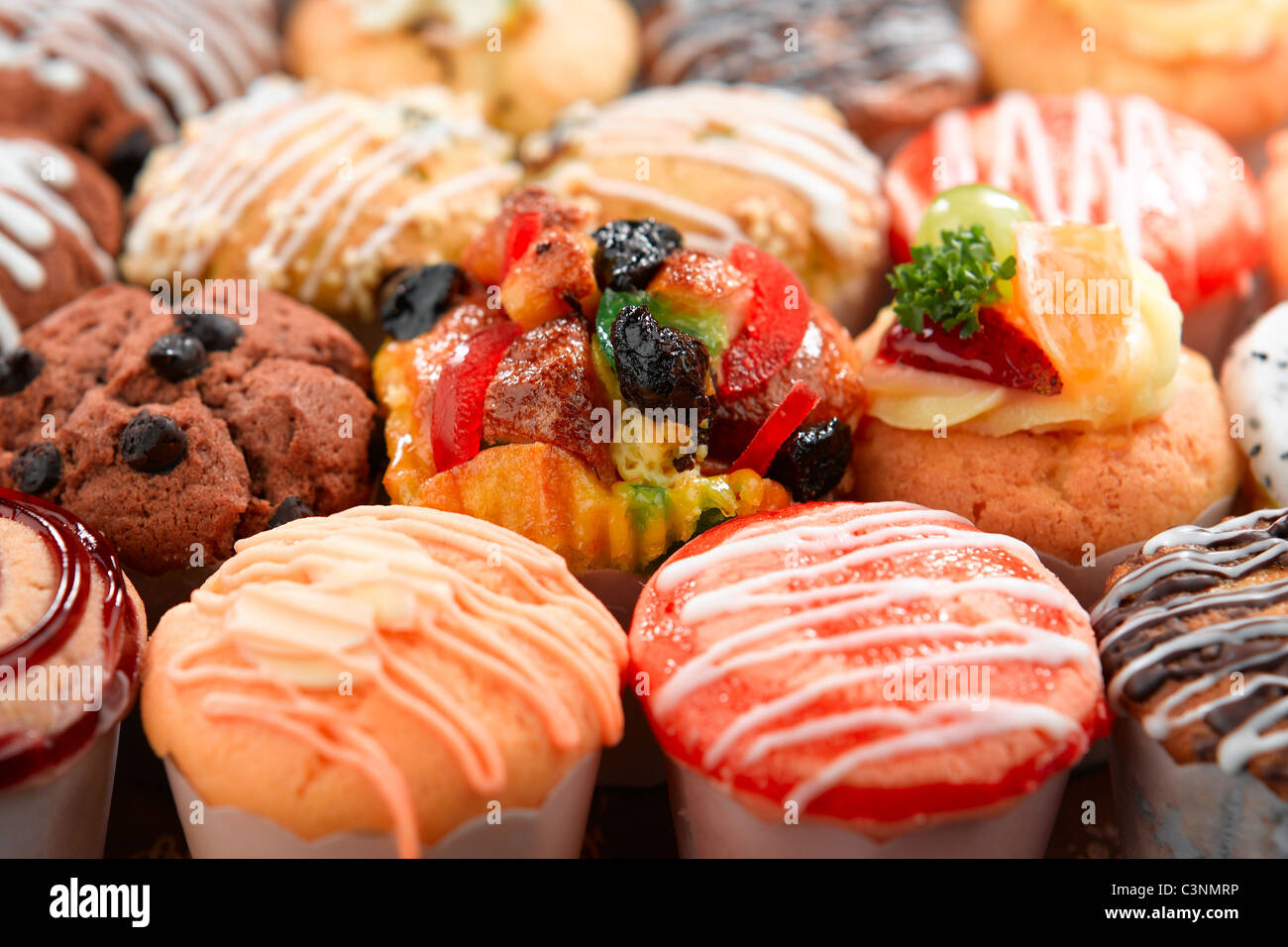 Colorful muffins in variety flavor arranges on tray ready made for ...