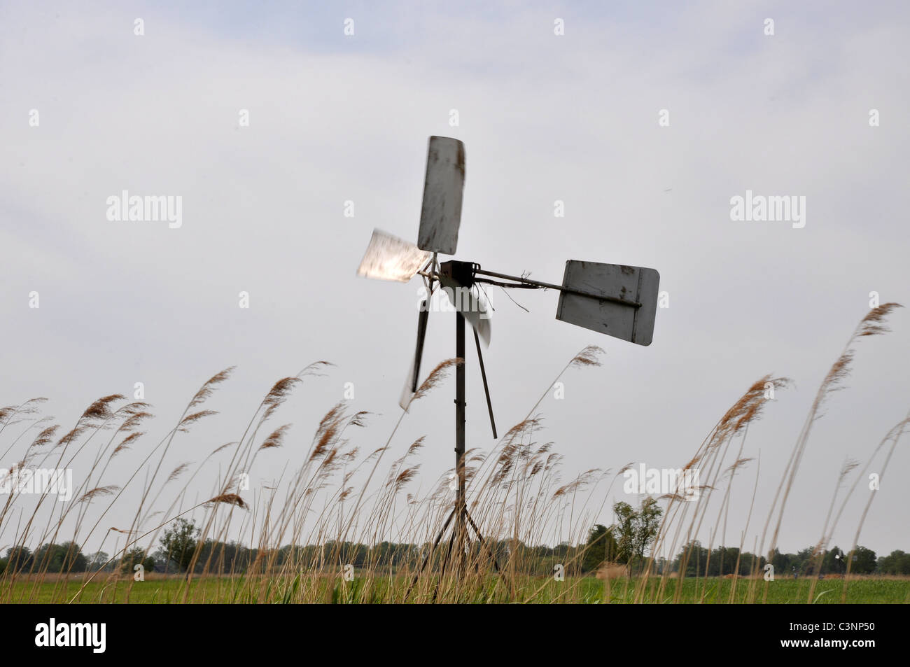 Windmill turning by wind in Dutch landscape Stock Photo - Alamy