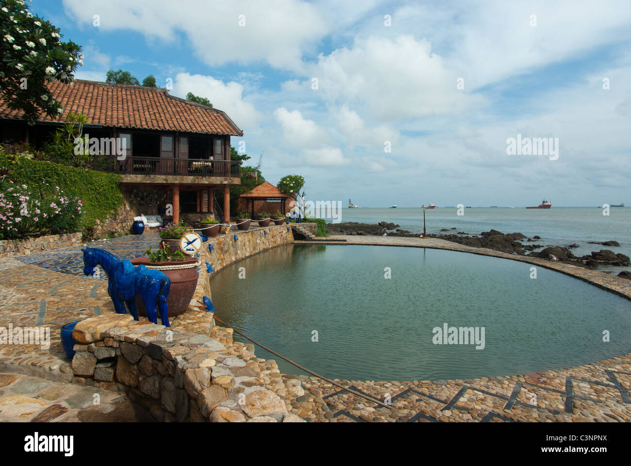 Vintage and cozy resort with swimming pool by the sea Stock Photo - Alamy