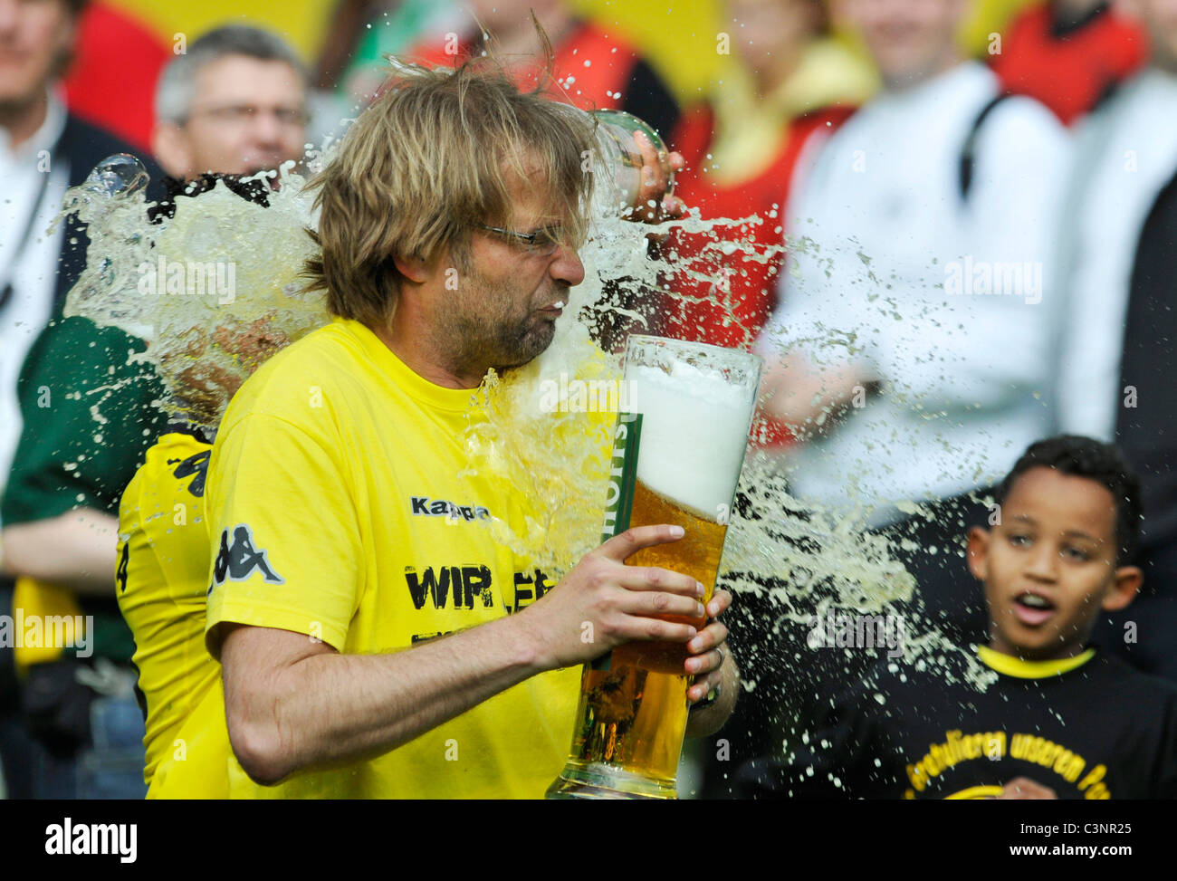 Dortmund coach manager Juergen Klopp gets showered with beer during ...