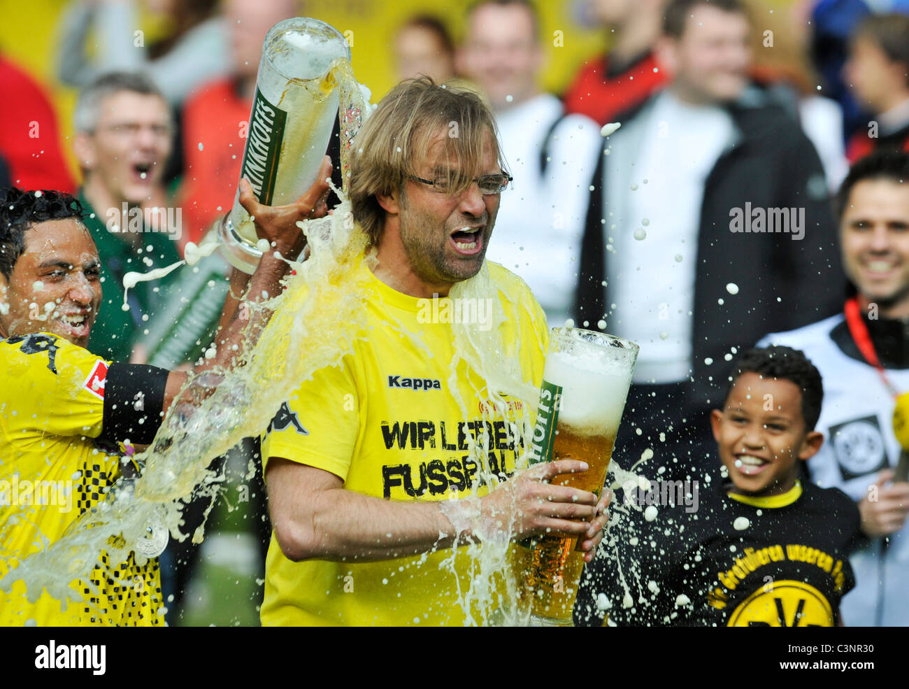 Dortmund coach manager Juergen Klopp gets showered with beer during ...