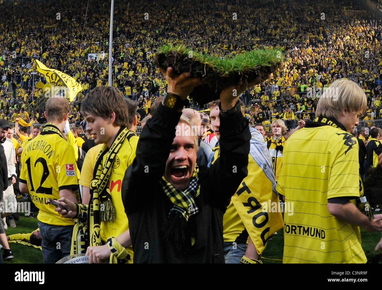 Fans of german football club Borussia Dortmund have flooded the pitch ...