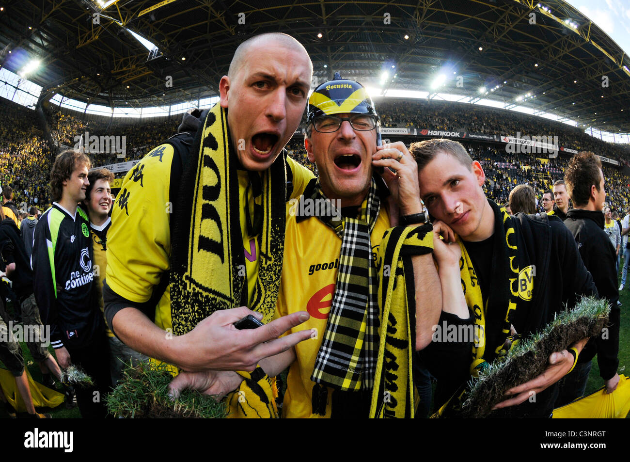 Fans of german football club Borussia Dortmund have flooded the pitch ...