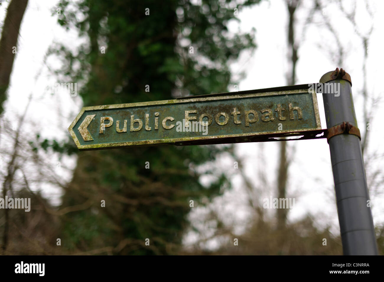 An old public footpath sign pointing left in Cornwall Stock Photo - Alamy