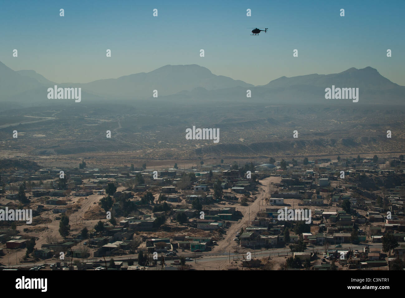Mexican Army helicopter patrols the slums of Anarba, one of the poorest ...