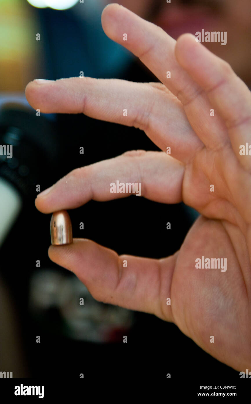 A bullet is examined by a criminal forensic expert at the Juarez City ...