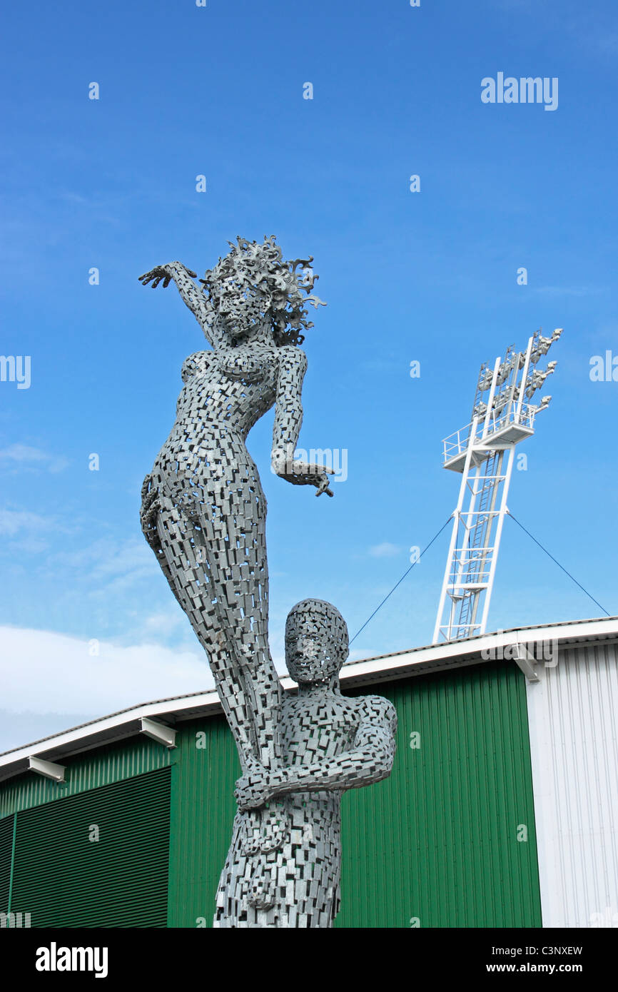 Nike and Hephaestus sculpture against a deep blue sky and a floodlight ...
