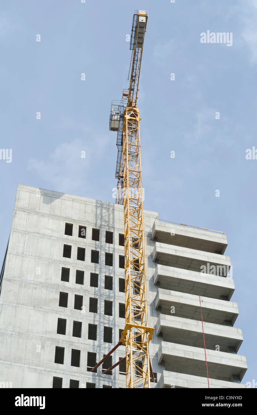 Construction crane by new building Stock Photo - Alamy