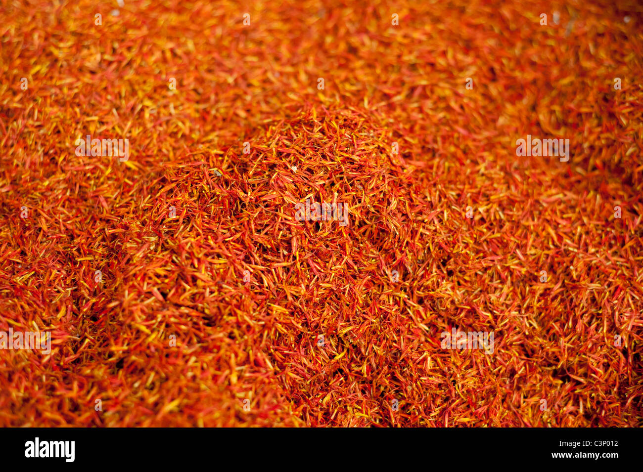 A pile of dried saffron fills a bin in a spice and dry goods store in ...