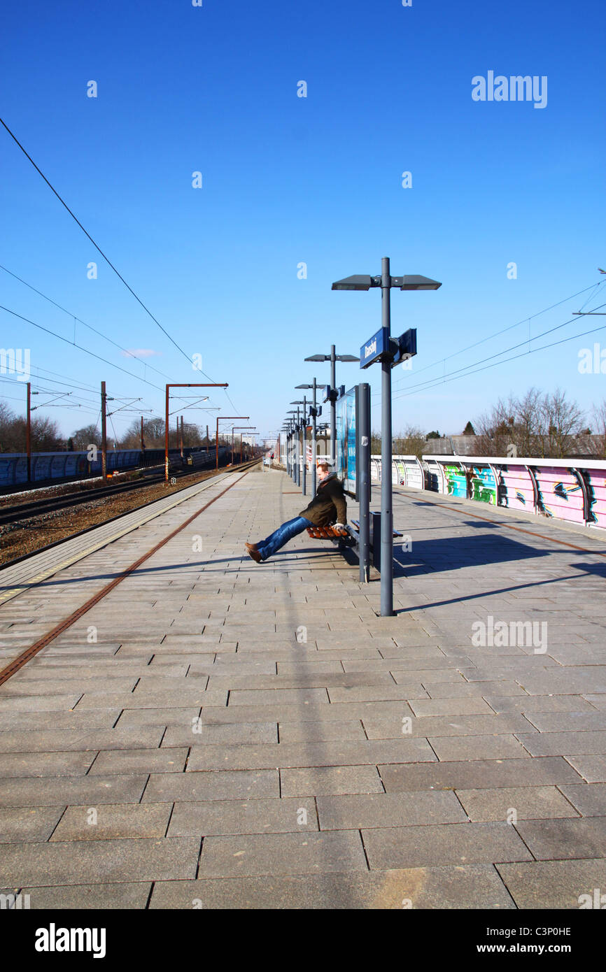Scandinavia man waiting platform pylons blue sky hi-res stock ...