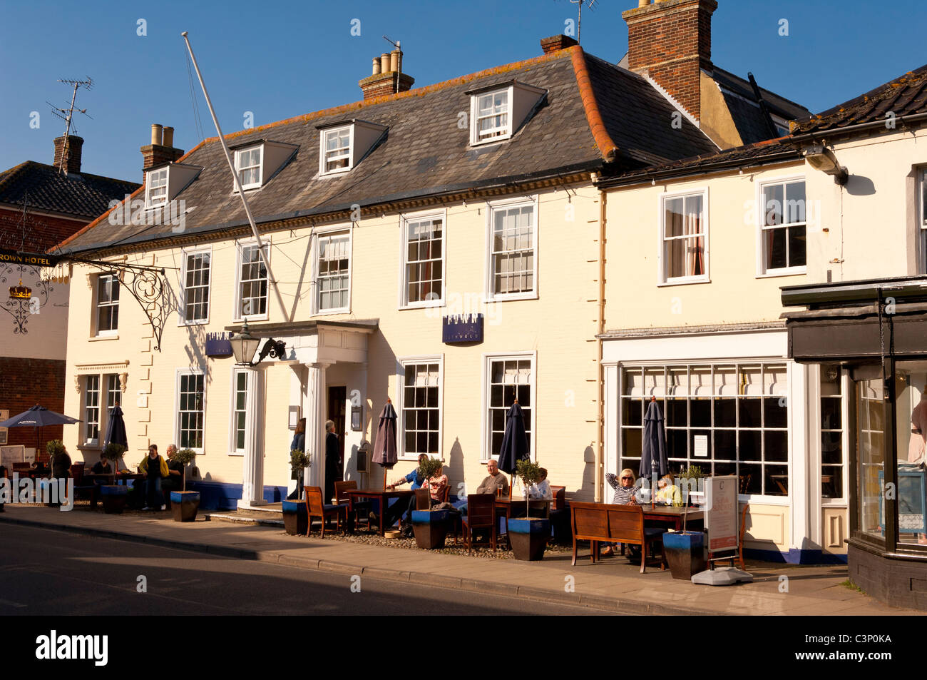 The Crown pub with customers sitting outside at Southwold , Suffolk ...