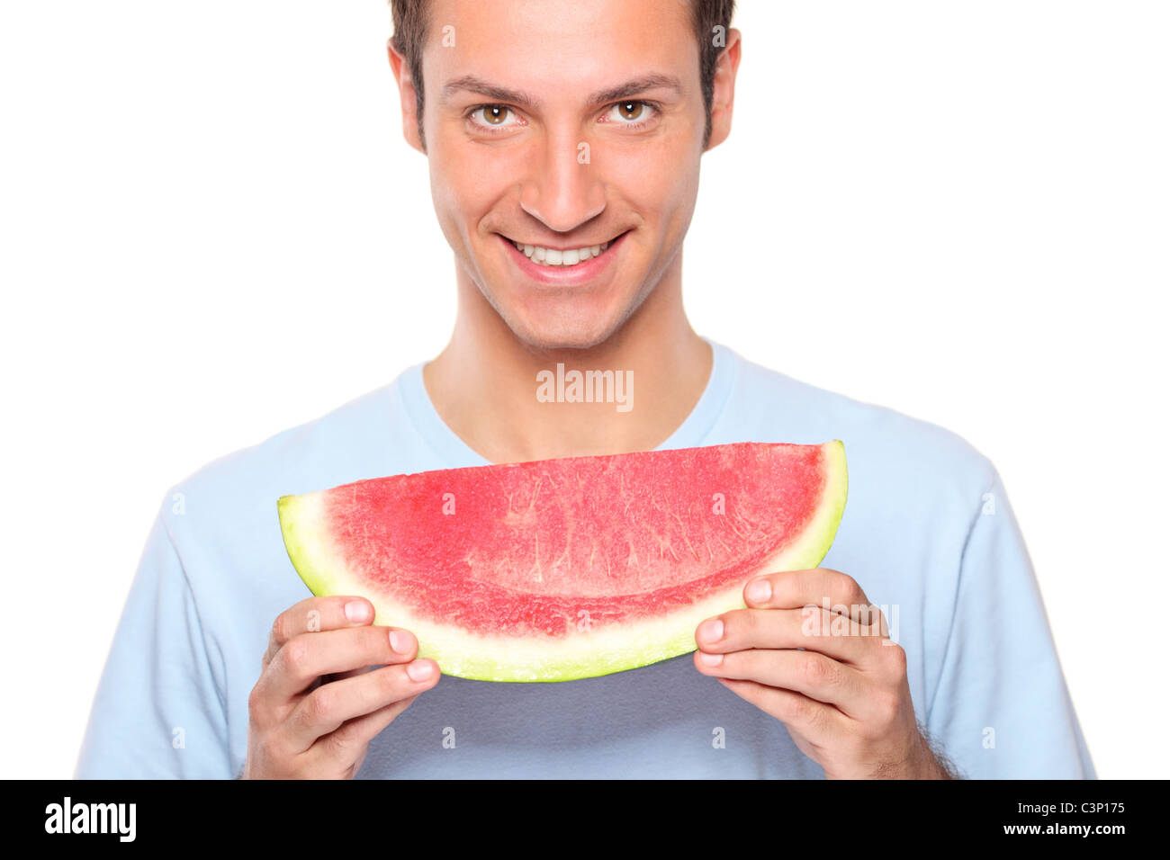 Smiling young man holding a slice of watermelon Stock Photo - Alamy