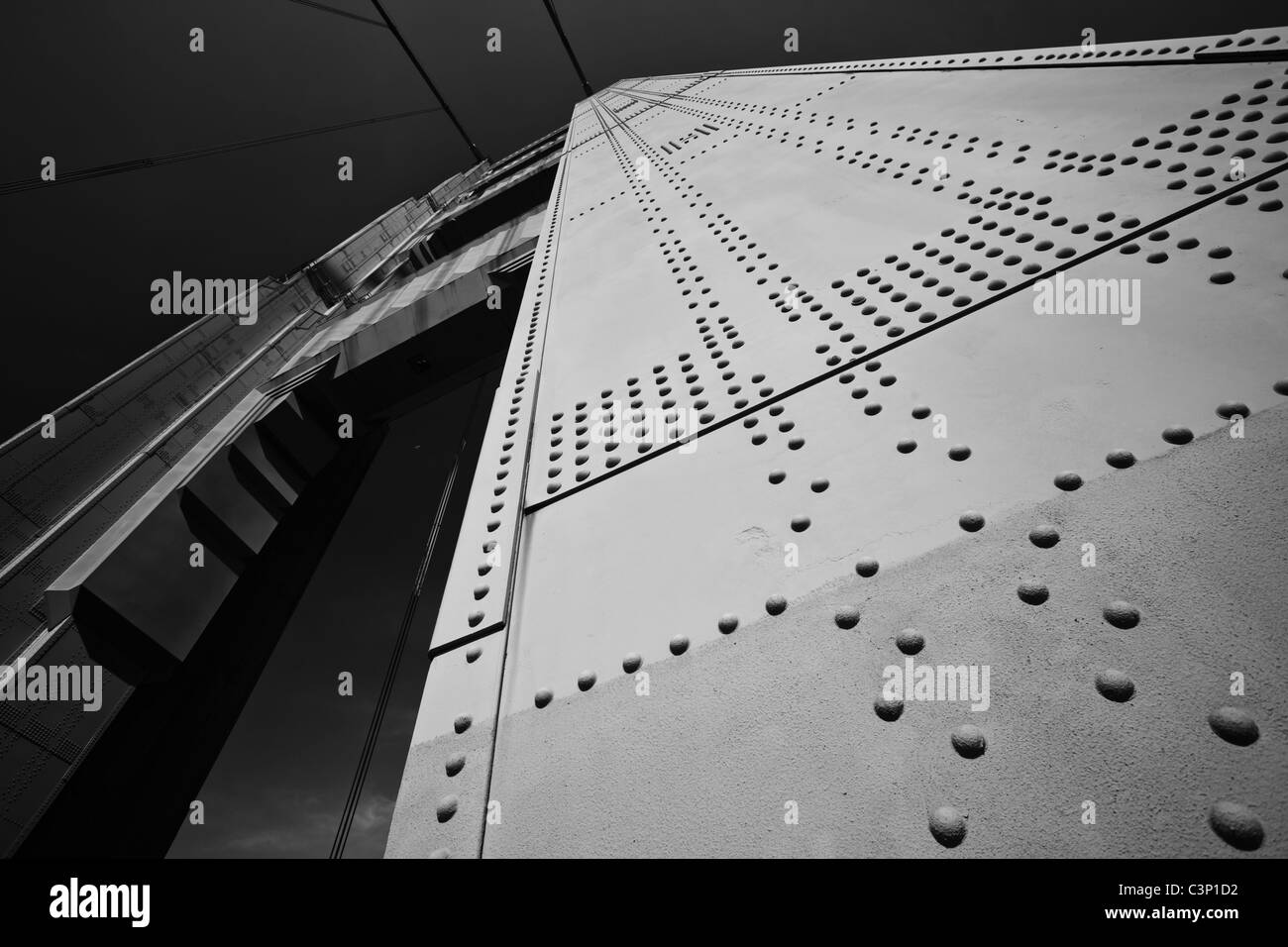 A low angle shot of a bridge support structure, showing the rivets and ...