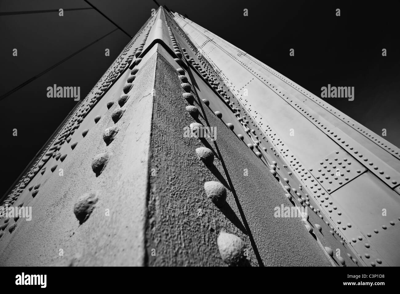 A low angle shot of a bridge support structure, showing the rivets and ...