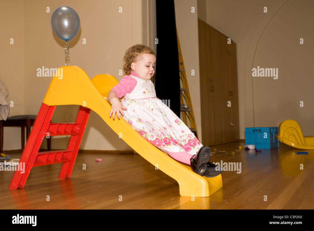 A toddler playng on a small slide Stock Photo - Alamy