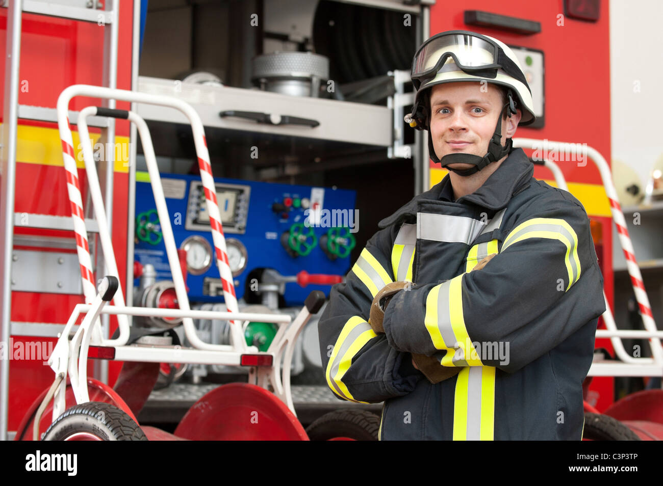 Picture from a young and successful firefighter at work Stock Photo - Alamy
