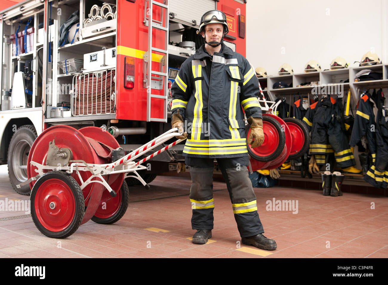 Picture from a young and successful firefighter at work Stock Photo - Alamy