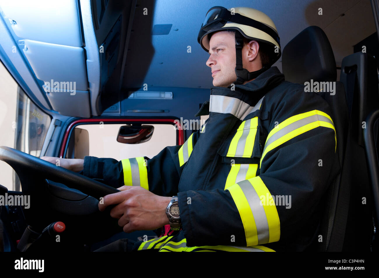 Picture from a young and successful firefighter at work Stock Photo - Alamy