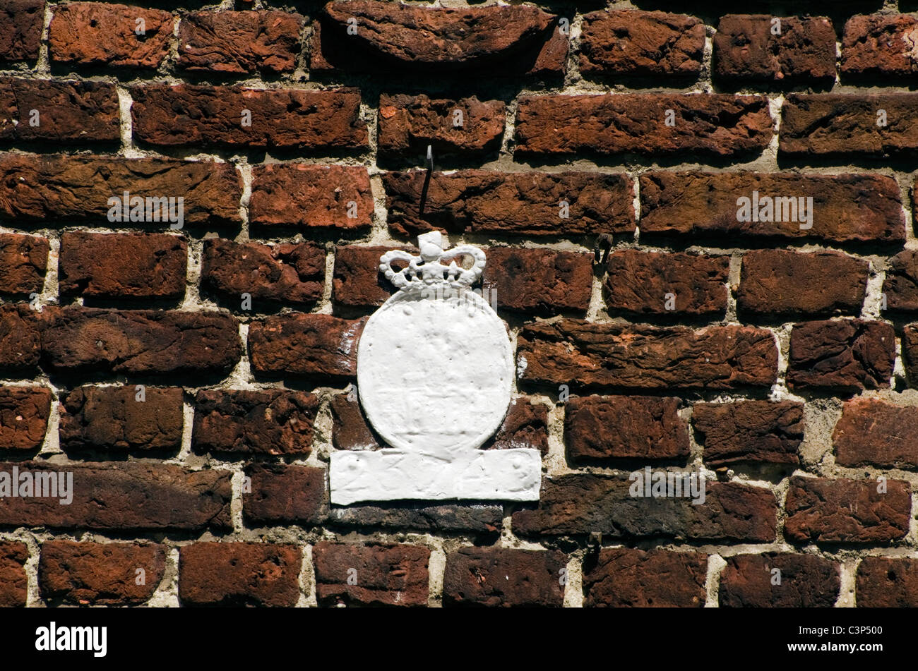 A wall mounted fire insurance metal wall plaque on a house in Denham ...