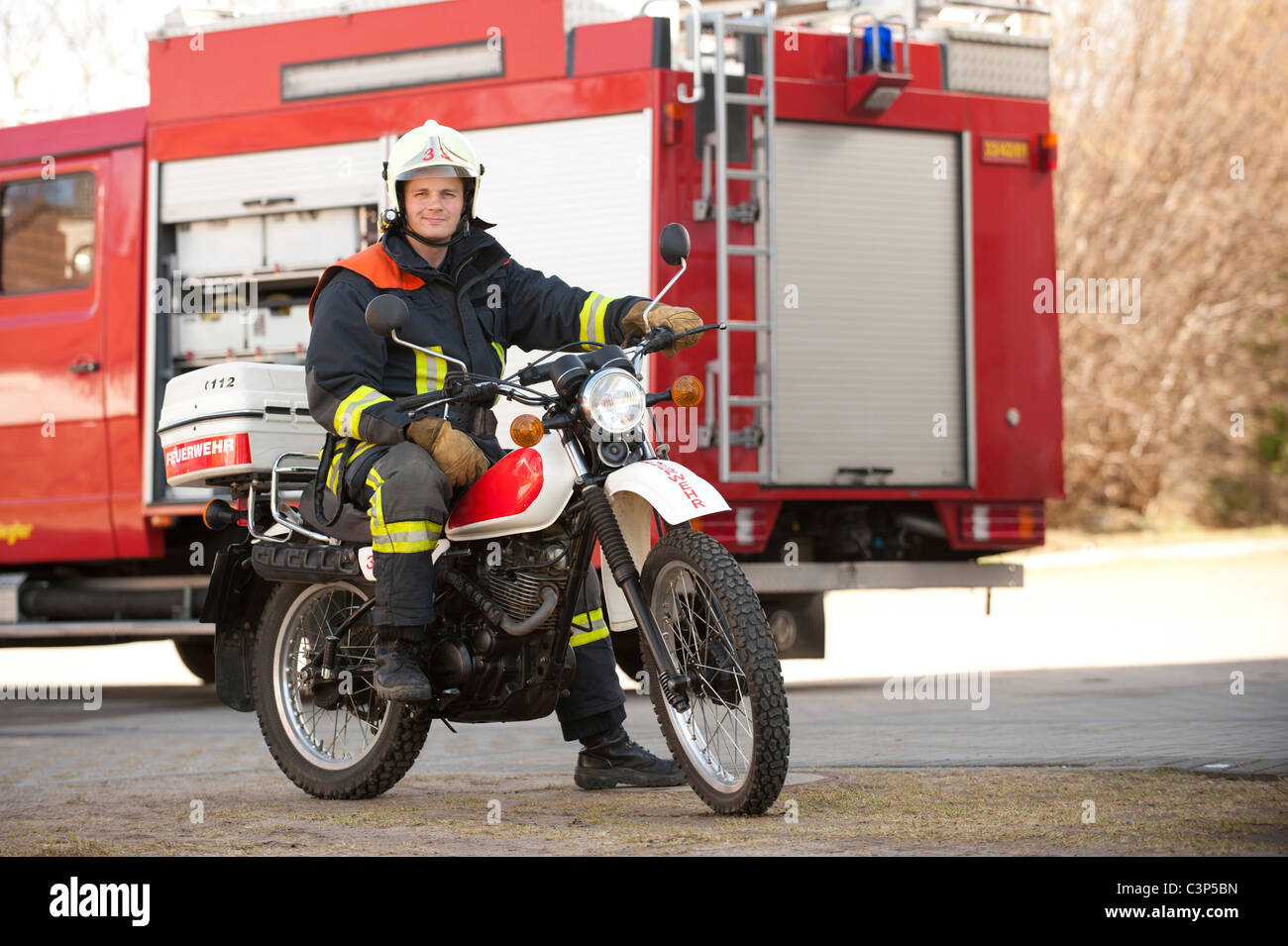 Picture from a young and successful firefighter at work Stock Photo - Alamy