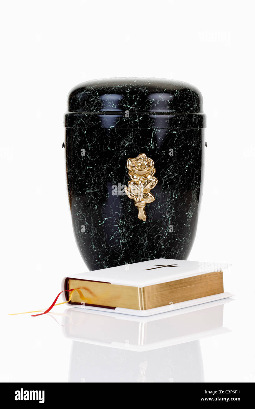 Cremation urn and bible Stock Photo - Alamy
