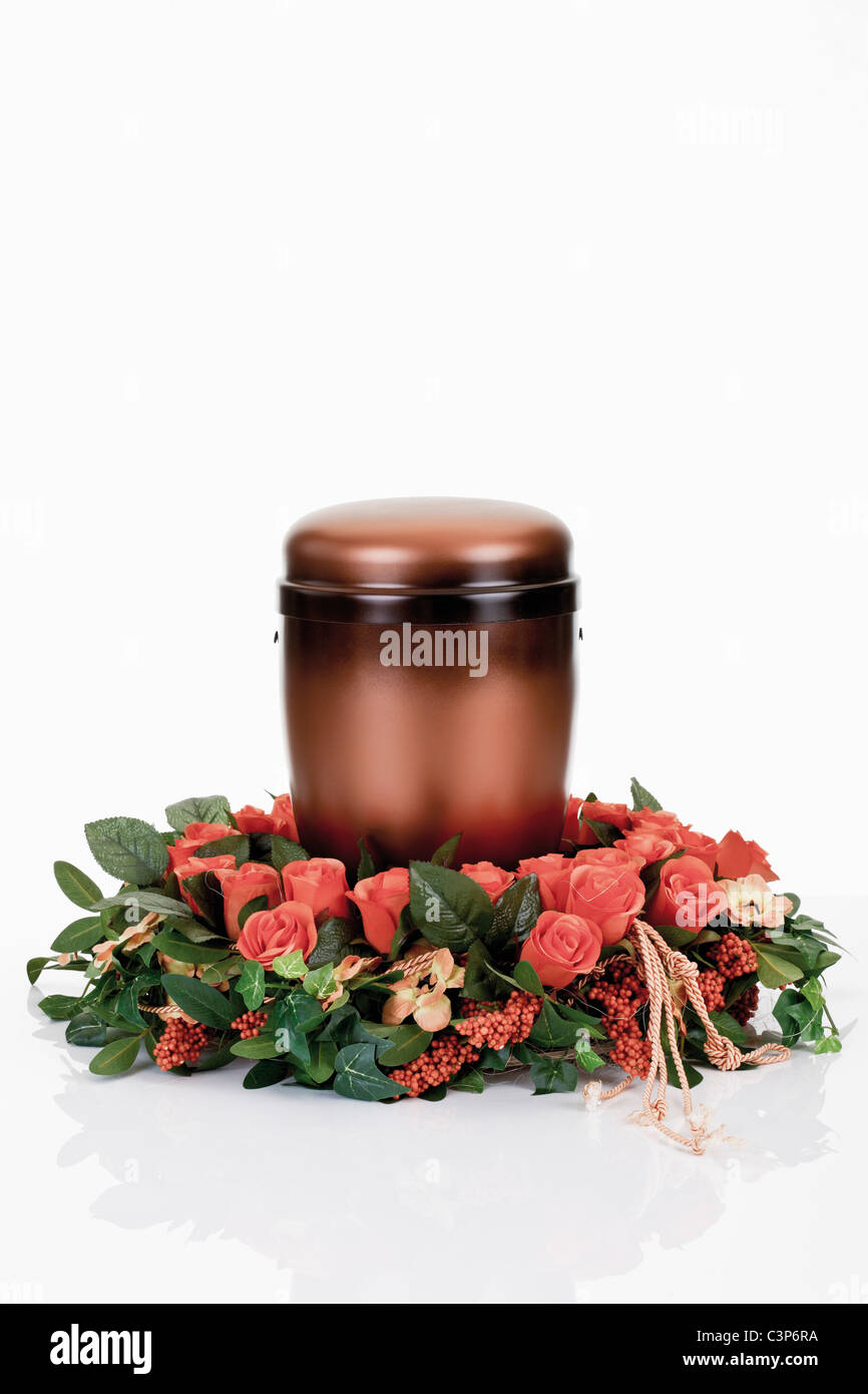 Cremation urn with floral wreath Stock Photo - Alamy
