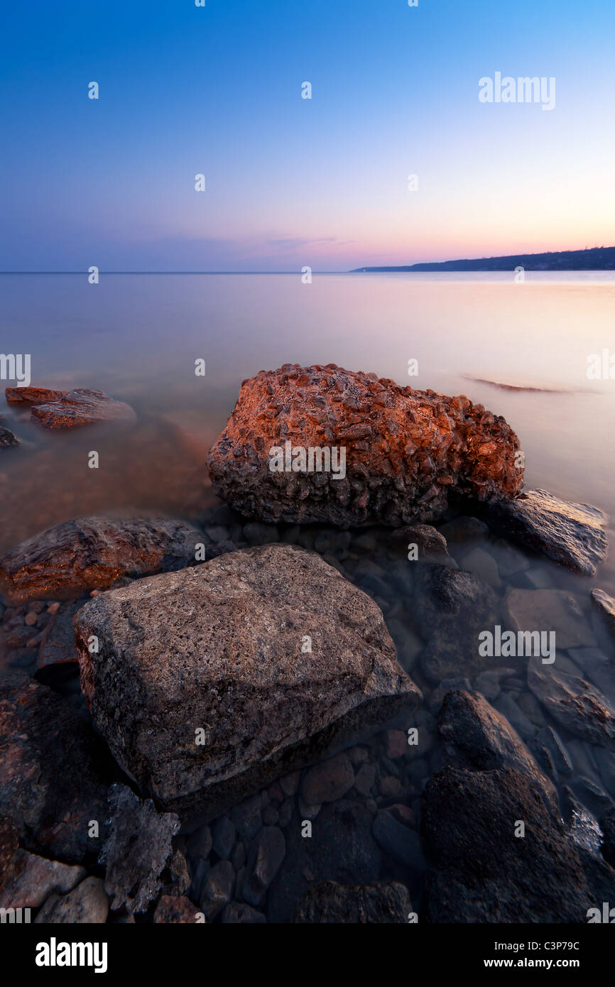 sunset on the rocky coast Stock Photo - Alamy