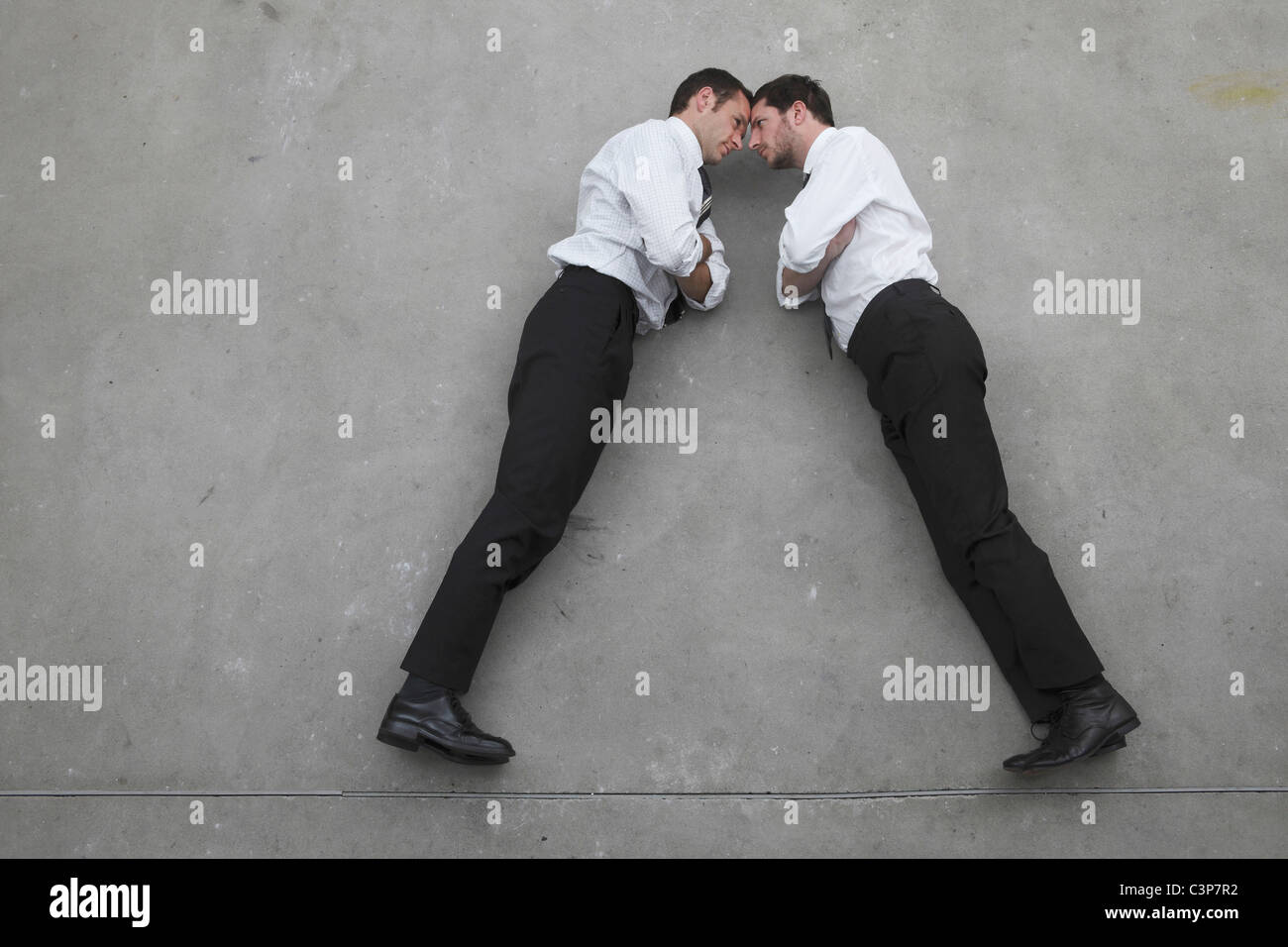 Two businessmen standing opposite to opposite, portrait, elevated view ...