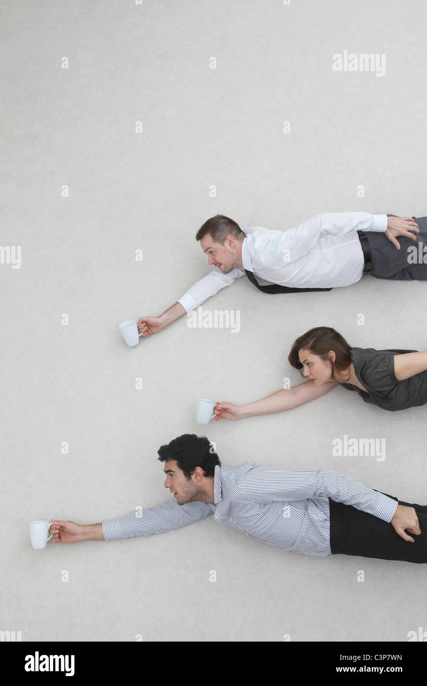 Flying business people holding coffee mugs, side view Stock Photo - Alamy