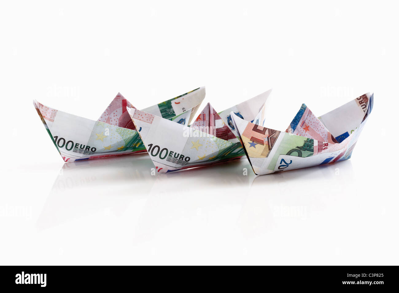 Origami paper boats of euro notes on white background Stock Photo - Alamy