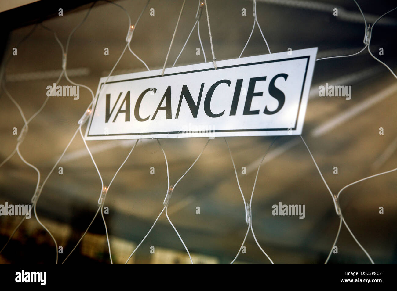 A vacancies sign in the window of a UK sea side hotel Stock Photo - Alamy
