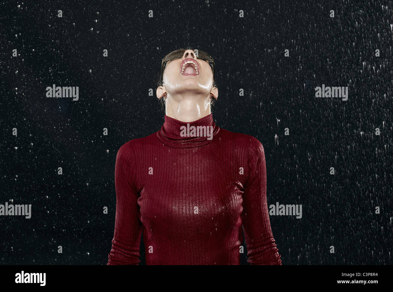Woman getting wet in rain Stock Photo - Alamy