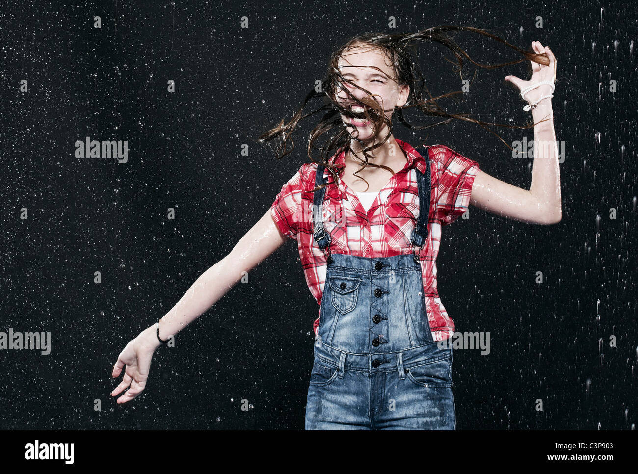 Girl jumping in rain, laughing Stock Photo - Alamy