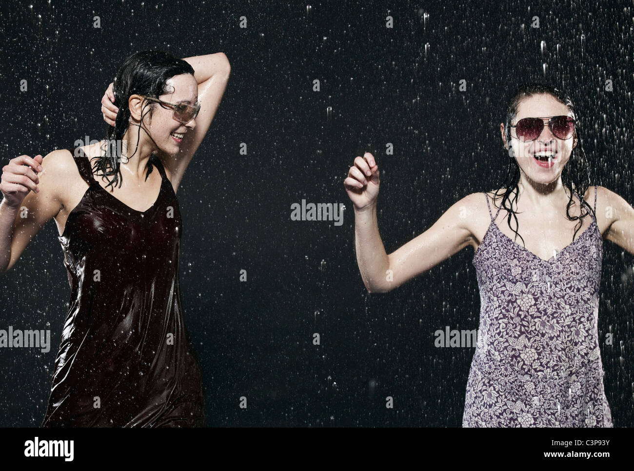 Friends enjoying in rain, smiling Stock Photo - Alamy