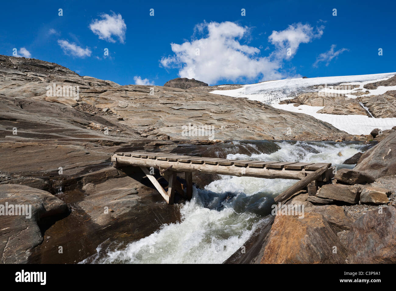 Austria, Grossglockner, Wooden bridge over mountain stream Stock Photo ...
