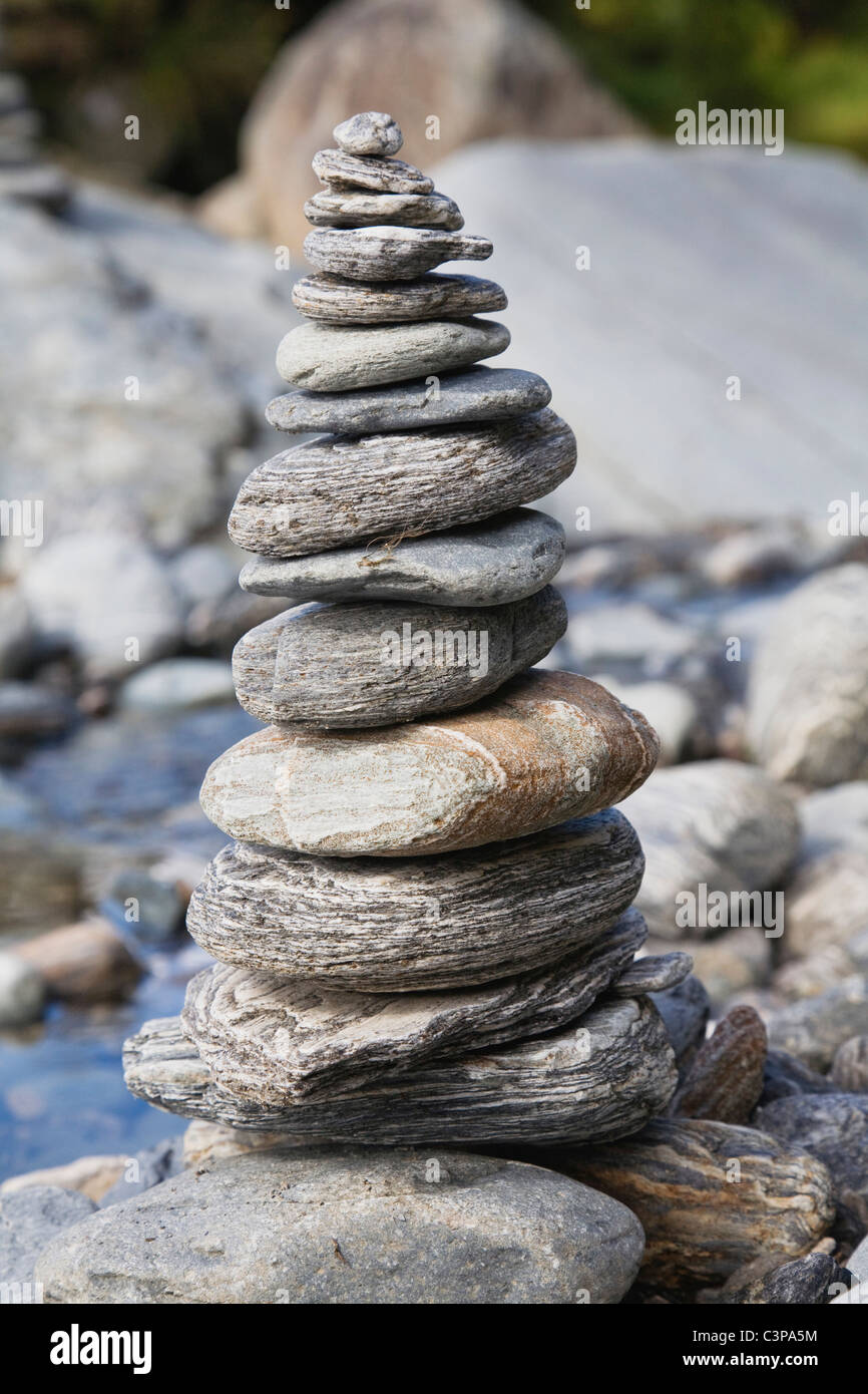 New Zealand, Stack of balanced stones on river, close-up Stock Photo ...