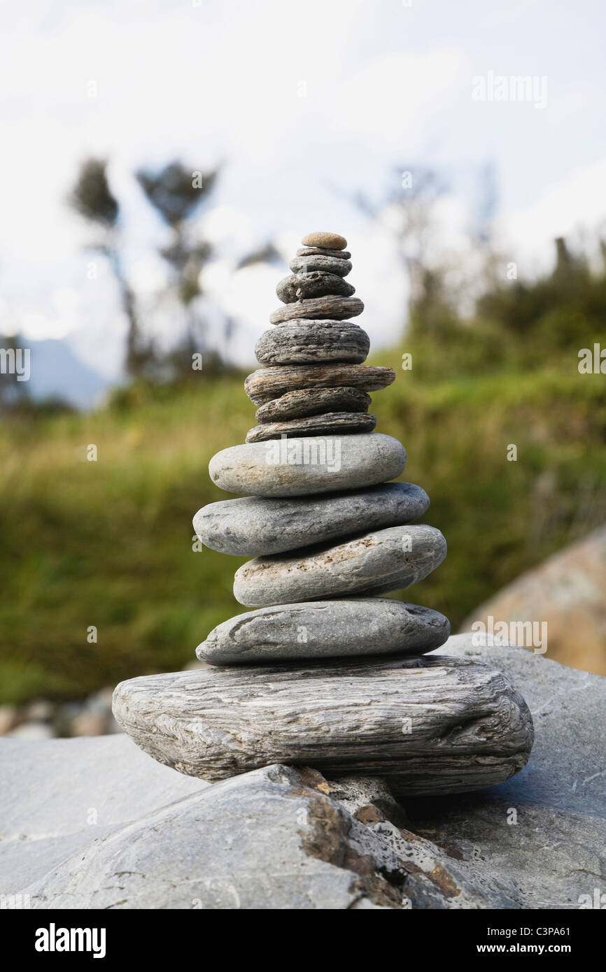 New Zealand, Stack of balanced stones in landscape, close-up Stock ...