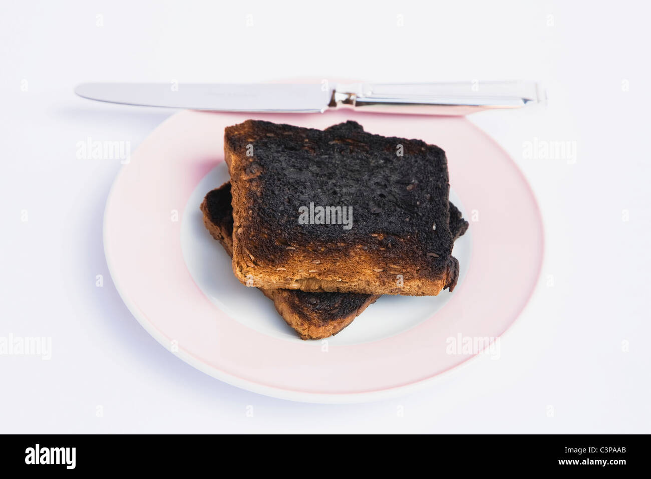 Burnt toast on plate Stock Photo - Alamy