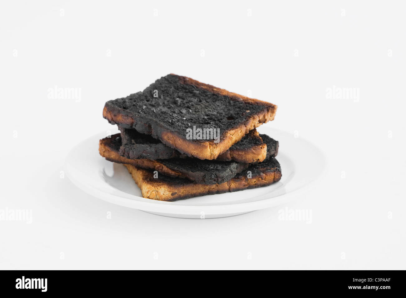 Burnt toast on plate Stock Photo - Alamy