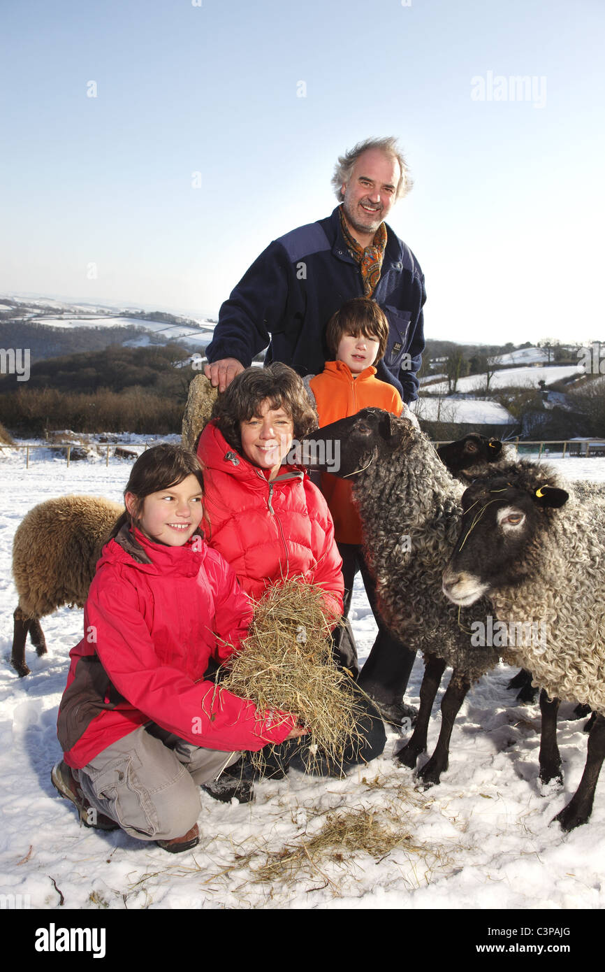Family outside their farmhouse in Devon, UK Stock Photo - Alamy