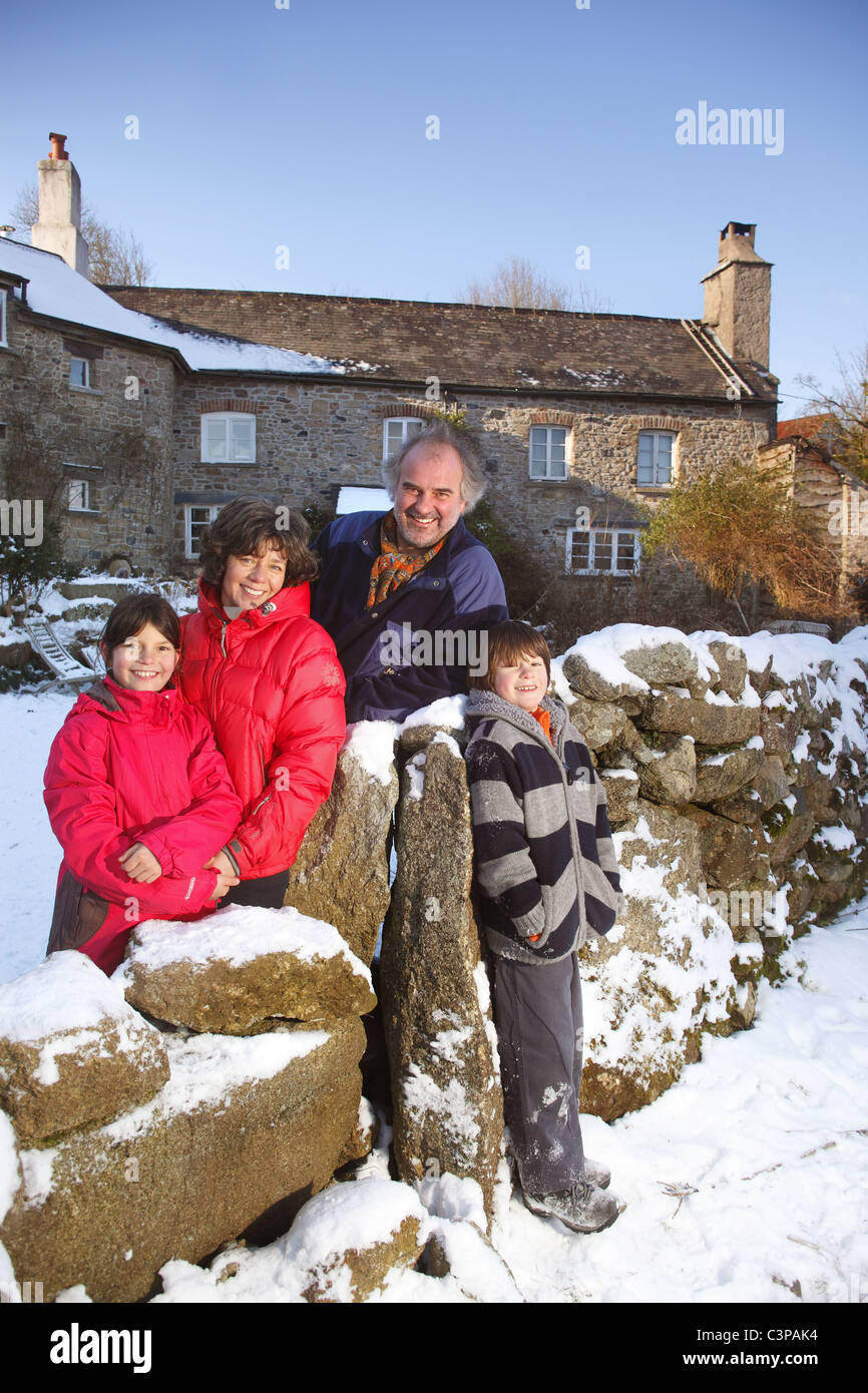 Family outside their farmhouse in Devon, UK Stock Photo - Alamy