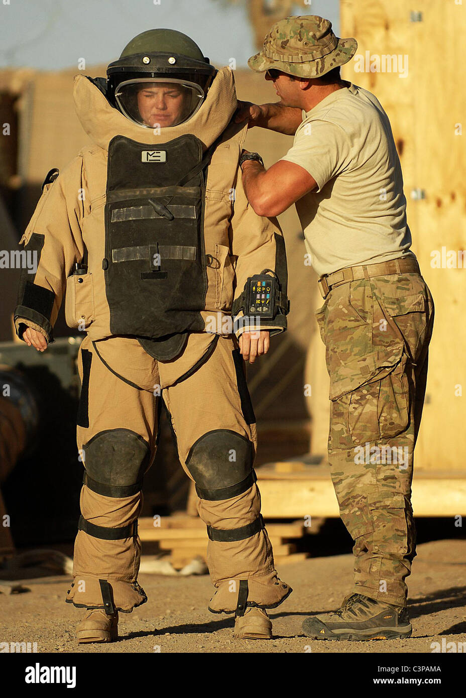 US Army soldier readies her protective bomb suite as the bomb disposal ...